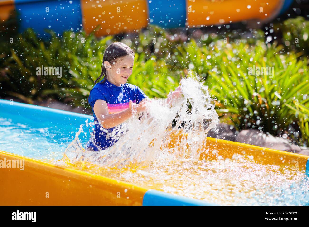 Kid on water slide hi-res stock photography and images - Alamy