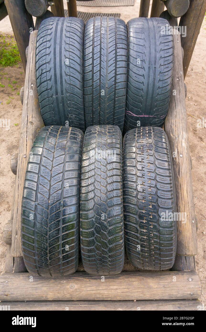 Lot of used old black tires in a wooden box Stock Photo - Alamy