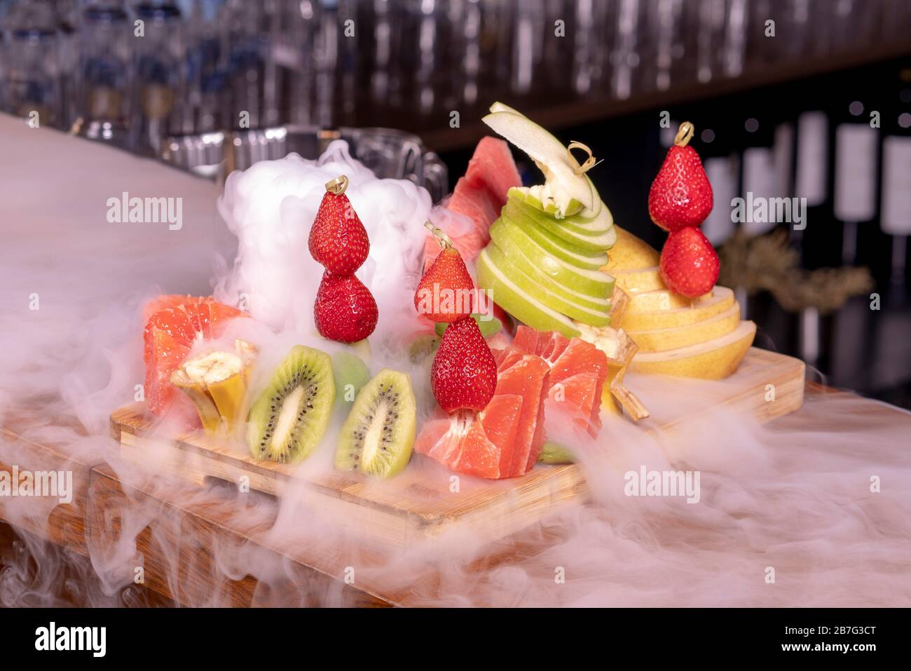 Fruit platter served with dry ice Stock Photo - Alamy