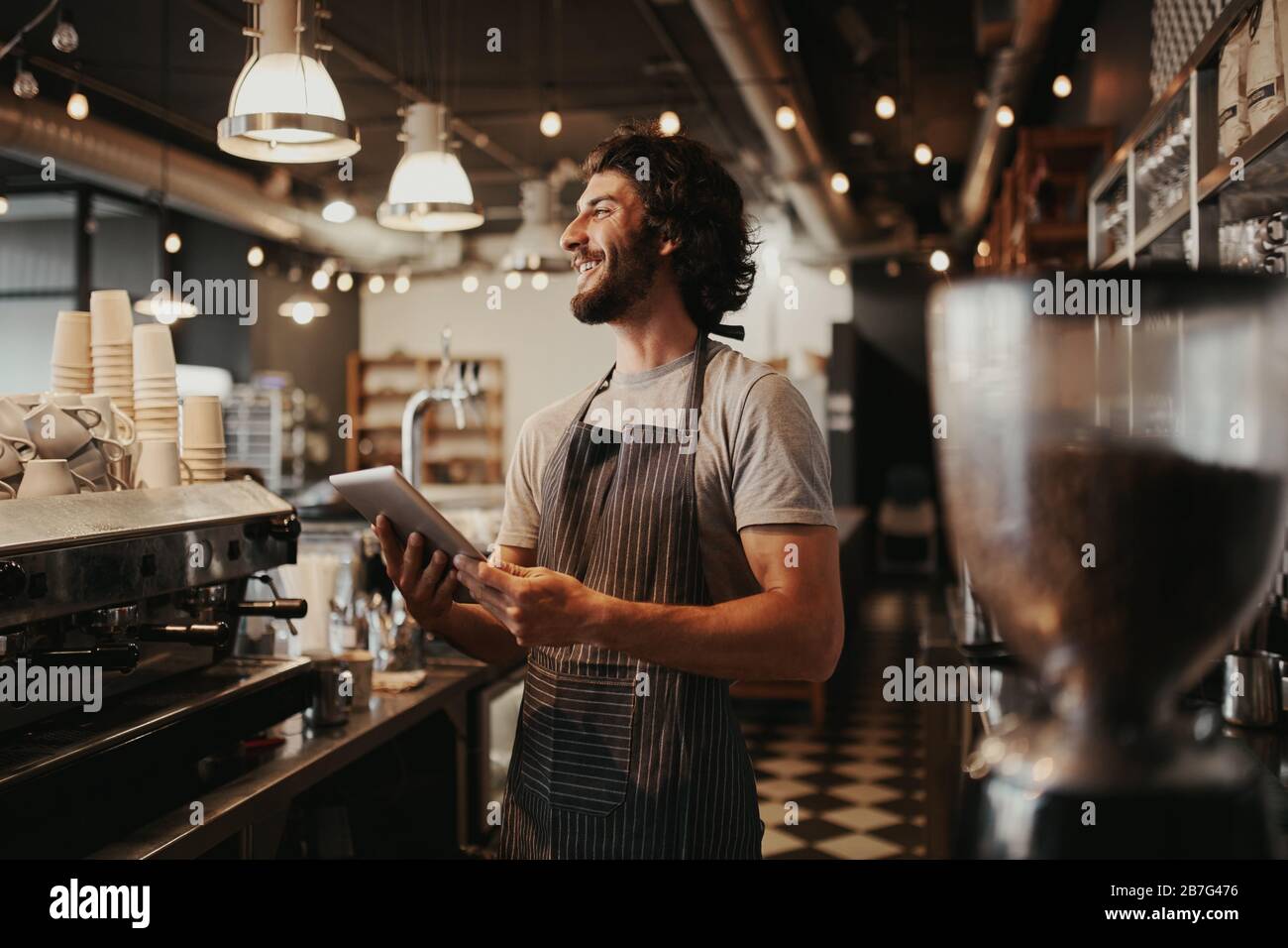 Man standing behind counter in hi-res stock photography and images - Alamy
