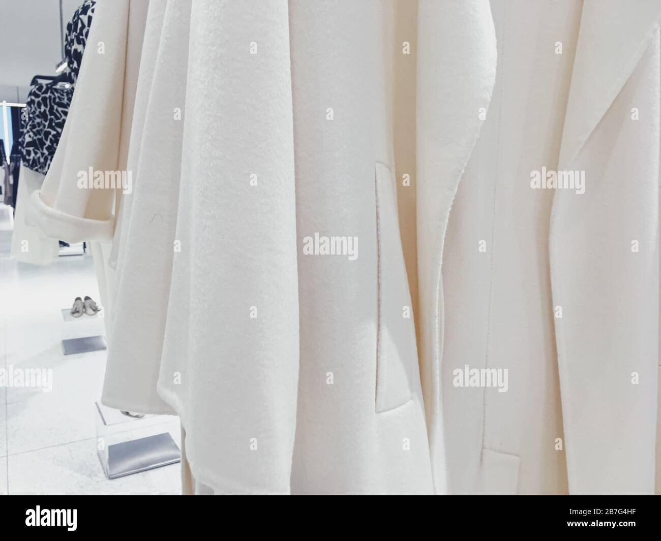 Clothing on display in a boutique store in shopping mall, fast fashion ...