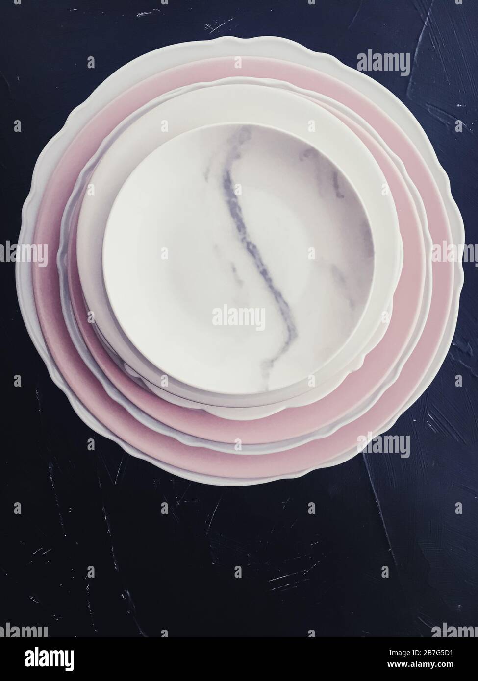 Stack of clean empty plates on black background, luxe dishware and ...