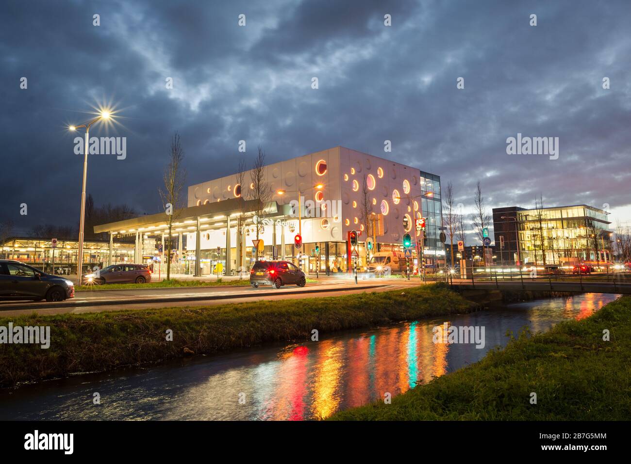 Central train station and cinema in the city of Gouda, Holland at night ...