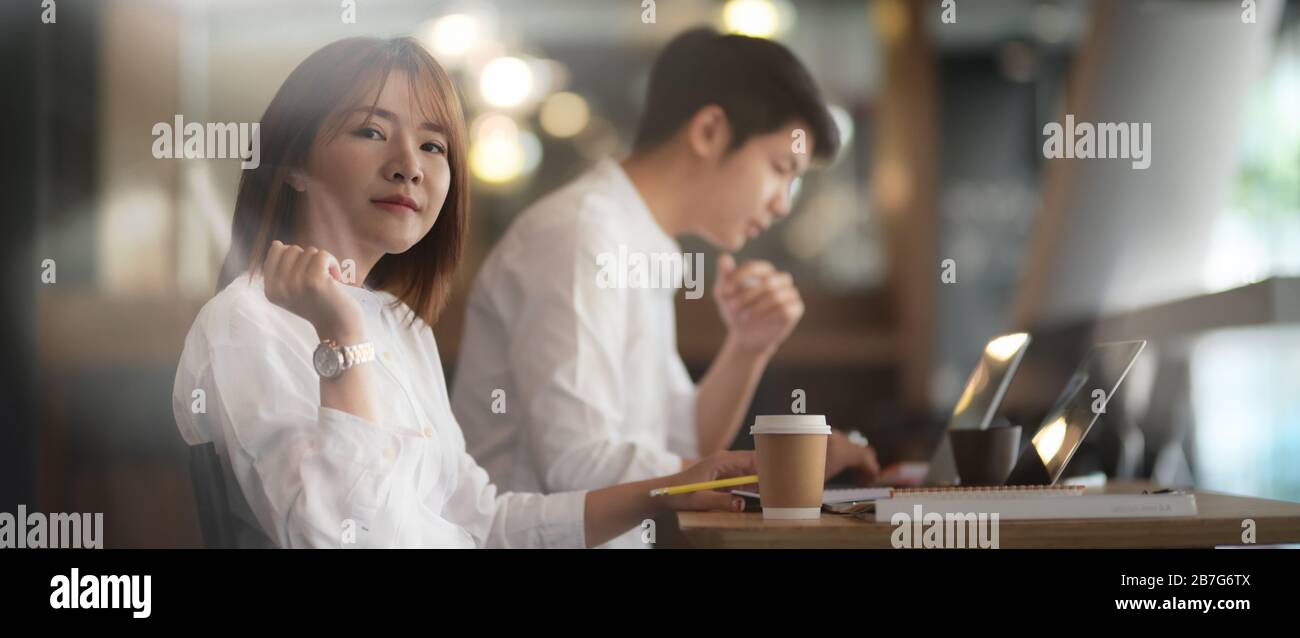 View through glass window of beauty businesswoman working with her ...