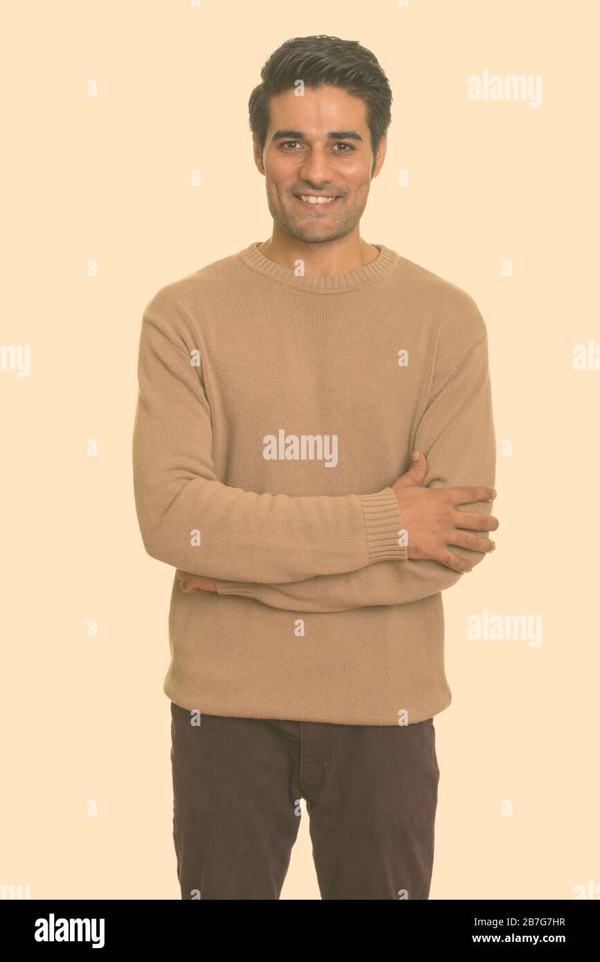 Portrait of happy handsome Persian man smiling with arms crossed Stock ...