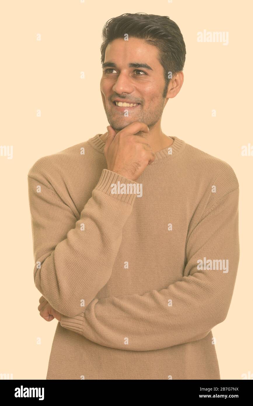 Portrait of happy handsome Persian man thinking Stock Photo - Alamy