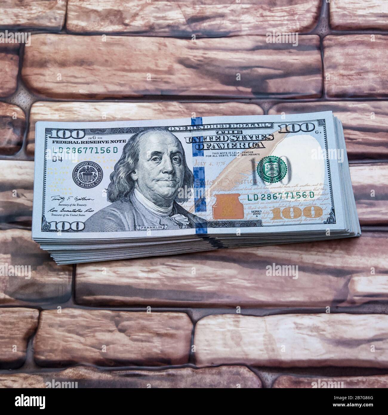 Dollars cash bills on a brick background Stock Photo - Alamy