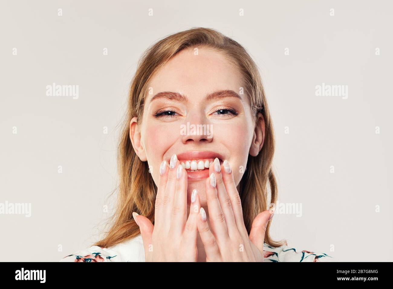Happy surprised woman laughing on white background Stock Photo - Alamy