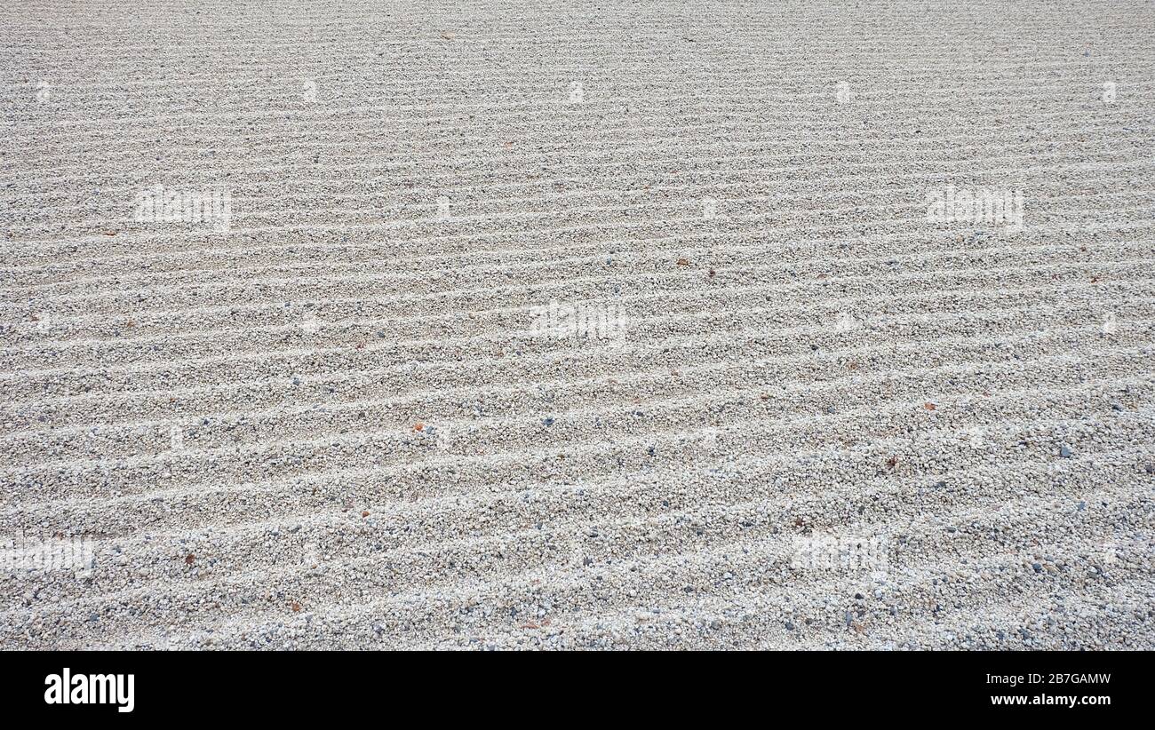 Texture of small pebbles, raked into parallel lines Stock Photo - Alamy