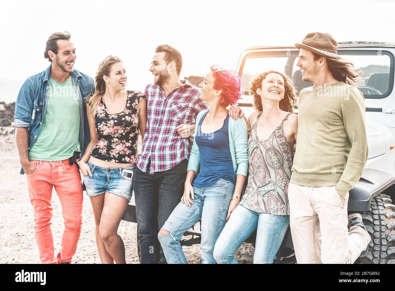 Happy friends doing excursion on desert with convertible 4x4 car ...