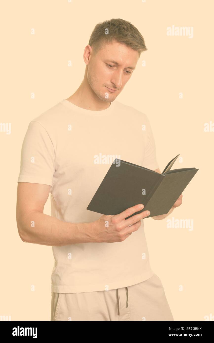 Portrait of handsome man with blond hair reading book Stock Photo - Alamy