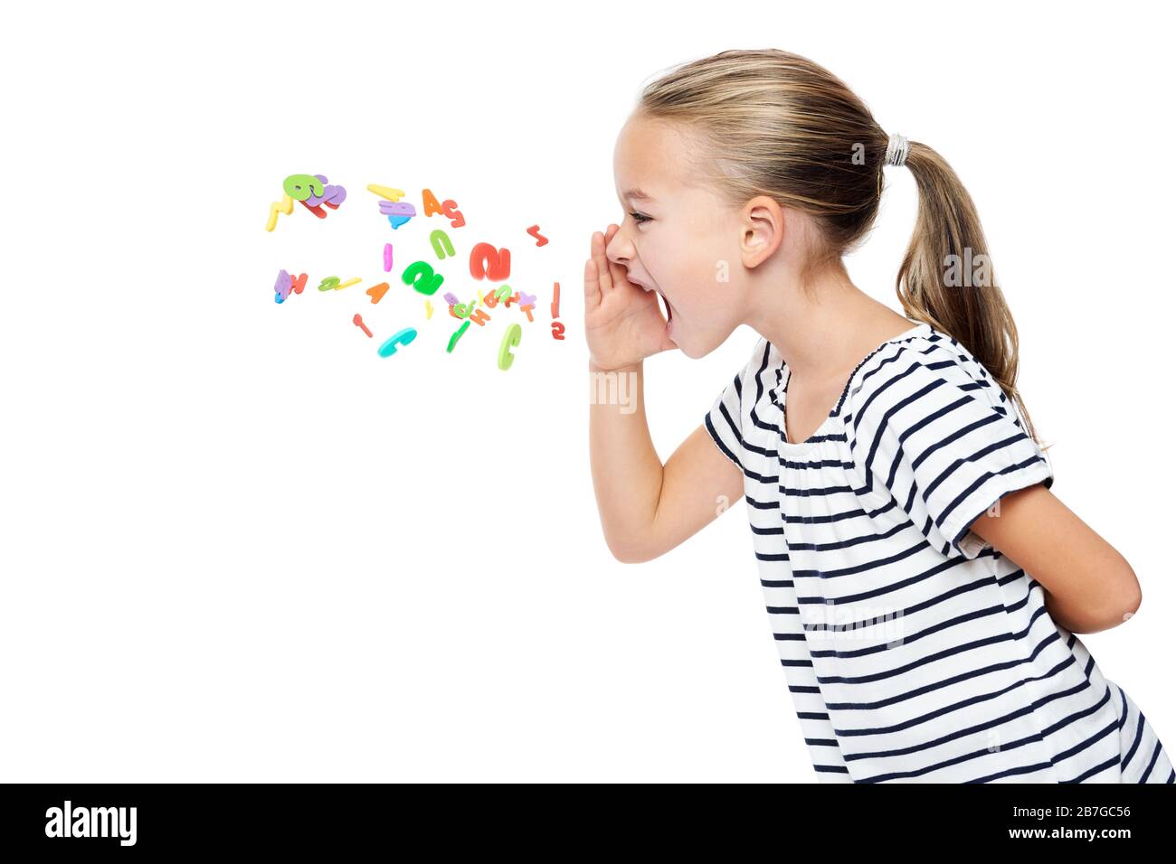 Cute little girl in stripped T-shirt shouting out alphabet letters ...