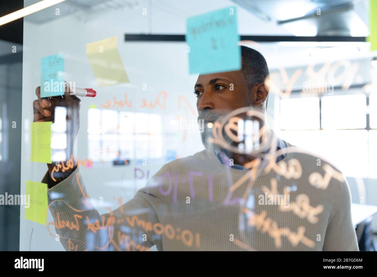 African American man writing on sticky notes Stock Photo - Alamy