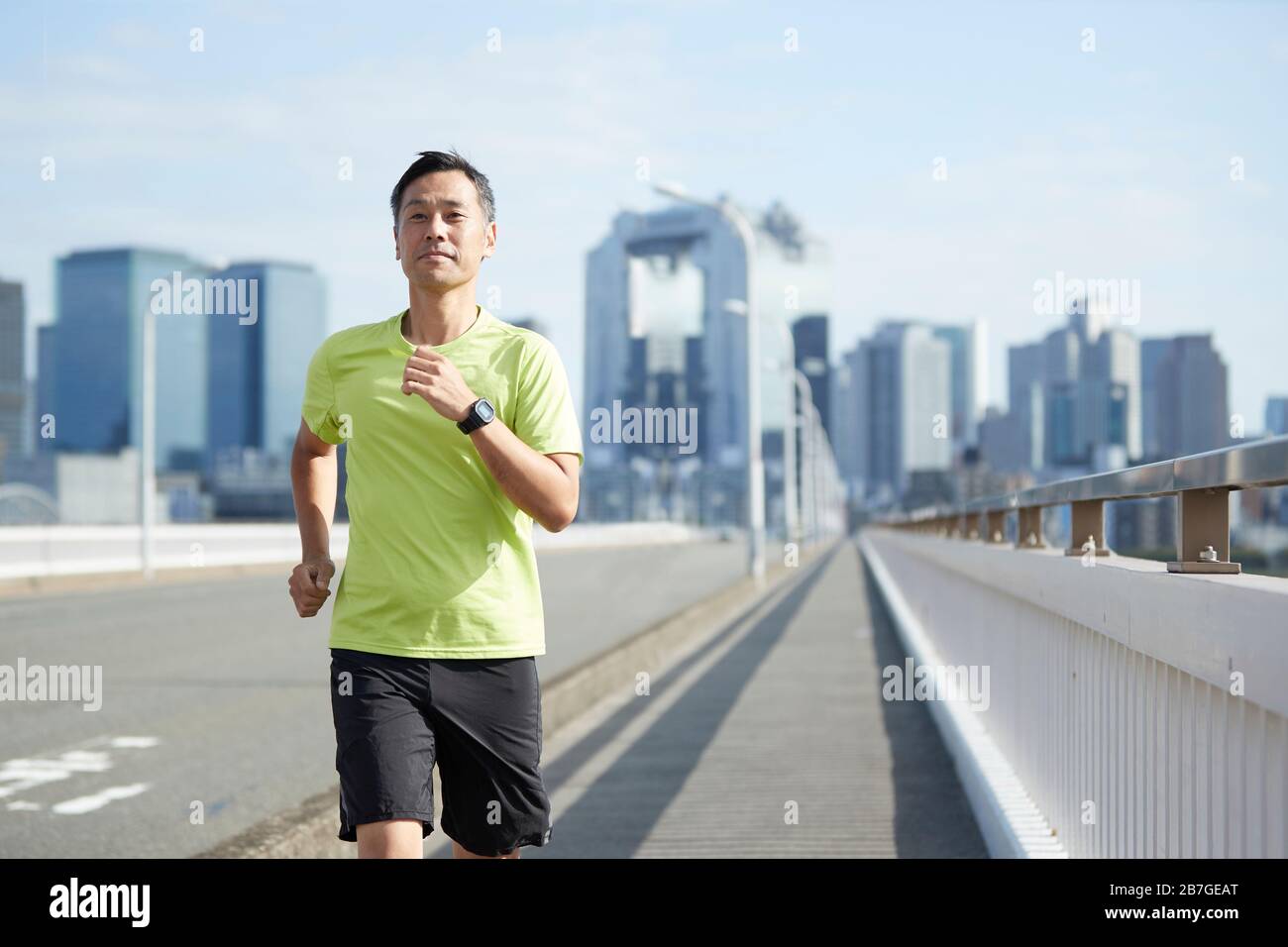 Mature Japanese man running downtown Osaka, Japan Stock Photo - Alamy