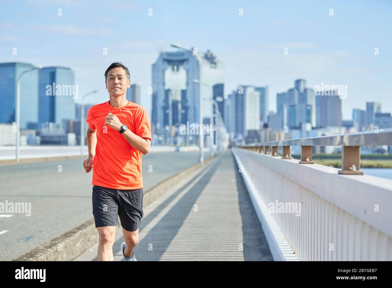 Mature Japanese man running downtown Osaka, Japan Stock Photo - Alamy