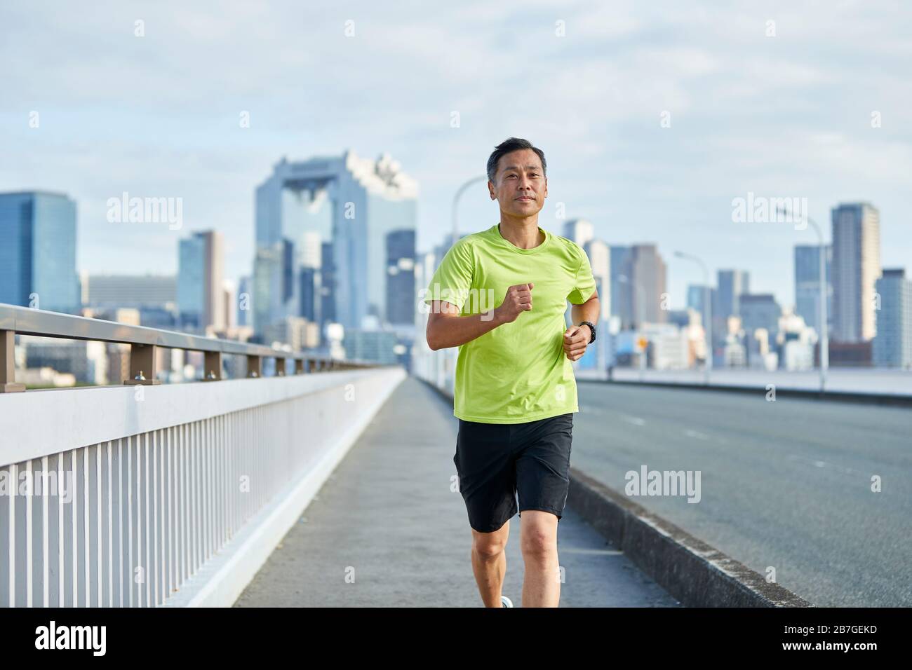 Mature Japanese man running downtown Osaka, Japan Stock Photo - Alamy