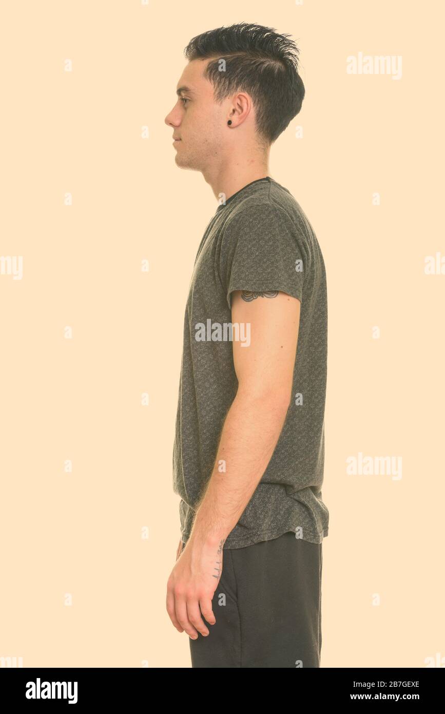 Profile view of young man standing Stock Photo - Alamy