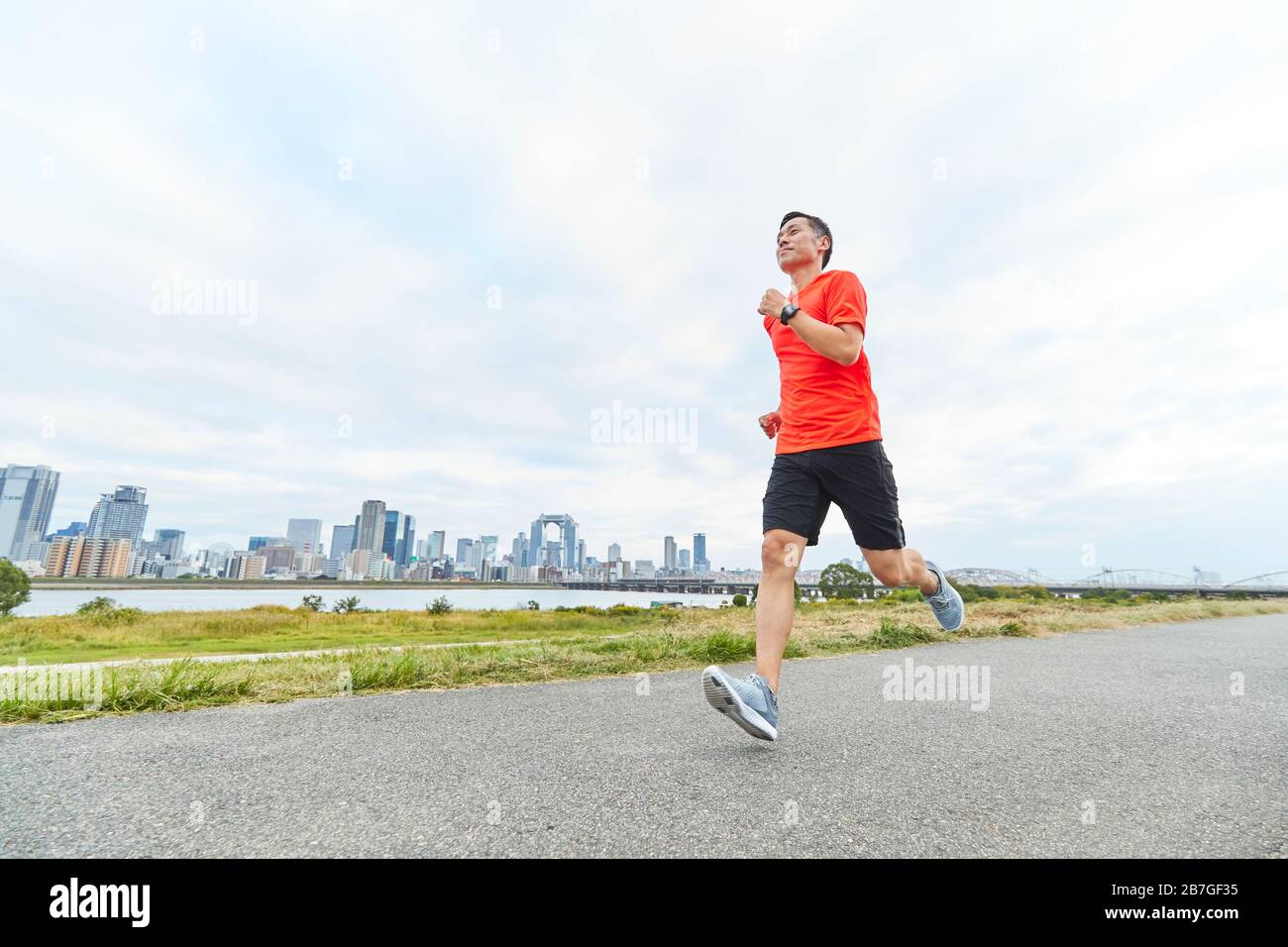 Mature Japanese man running downtown Osaka, Japan Stock Photo - Alamy