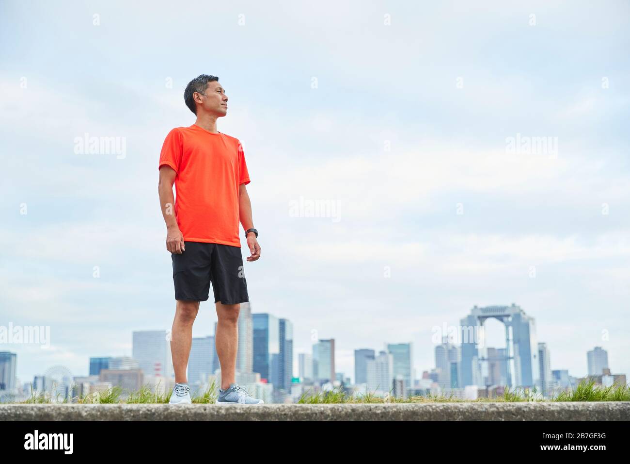 Mature Japanese man running downtown Osaka, Japan Stock Photo - Alamy
