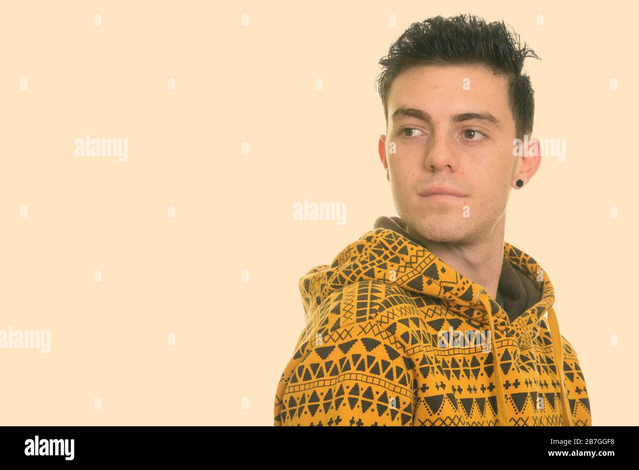 Studio shot of young man looking back Stock Photo - Alamy