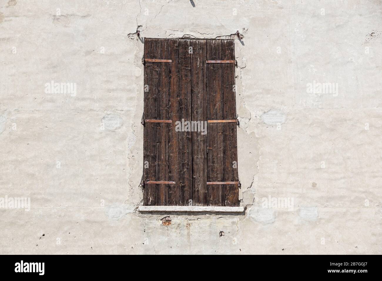 Abandoned, ruined old wooden Windows and wall with damaged old roof ...