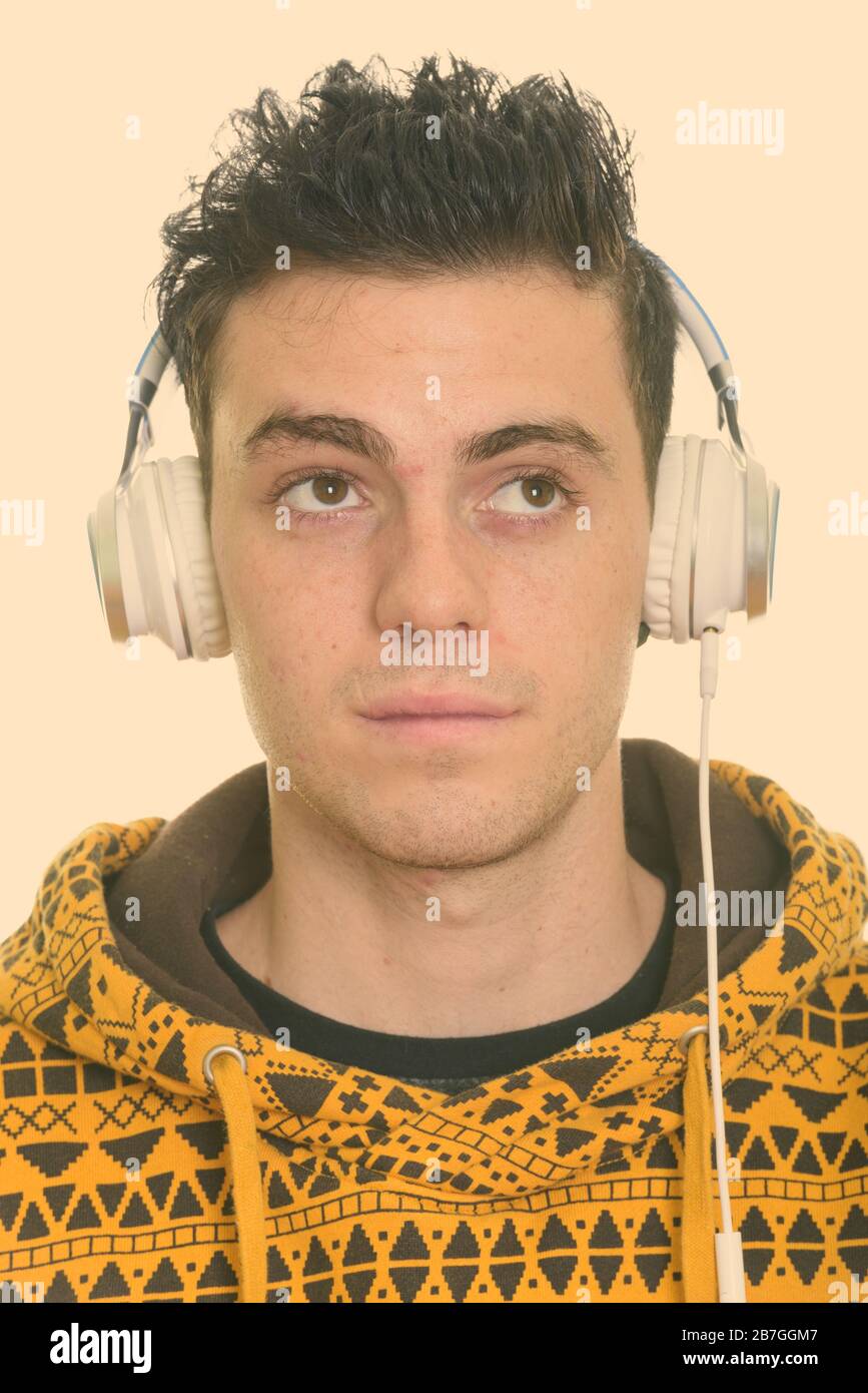 Face of young man listening to music while thinking Stock Photo - Alamy