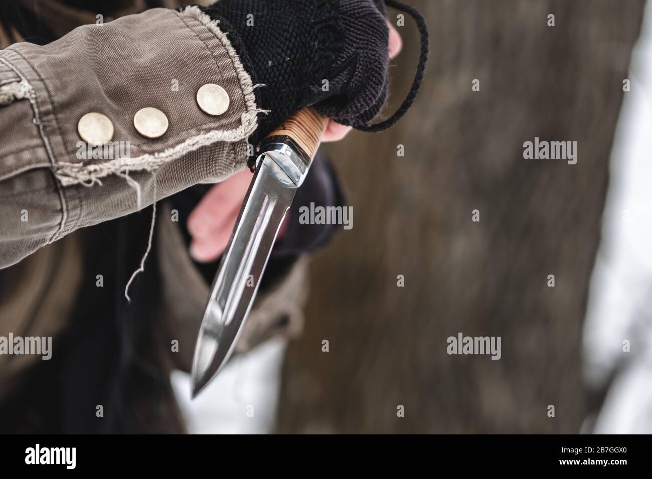 Military mercenary holds a steel knife in his hand. Close up Stock ...