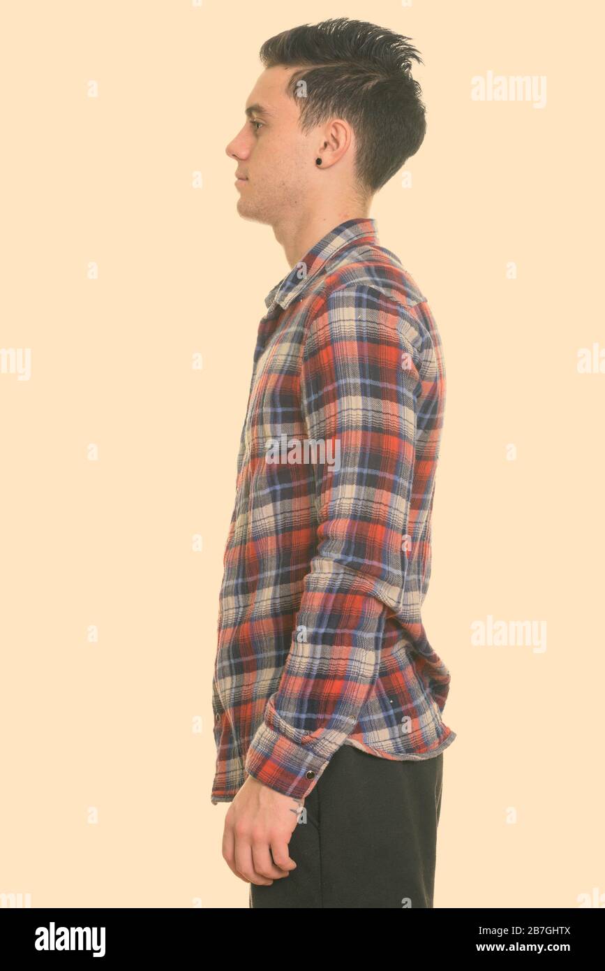 Profile view of young man standing Stock Photo - Alamy