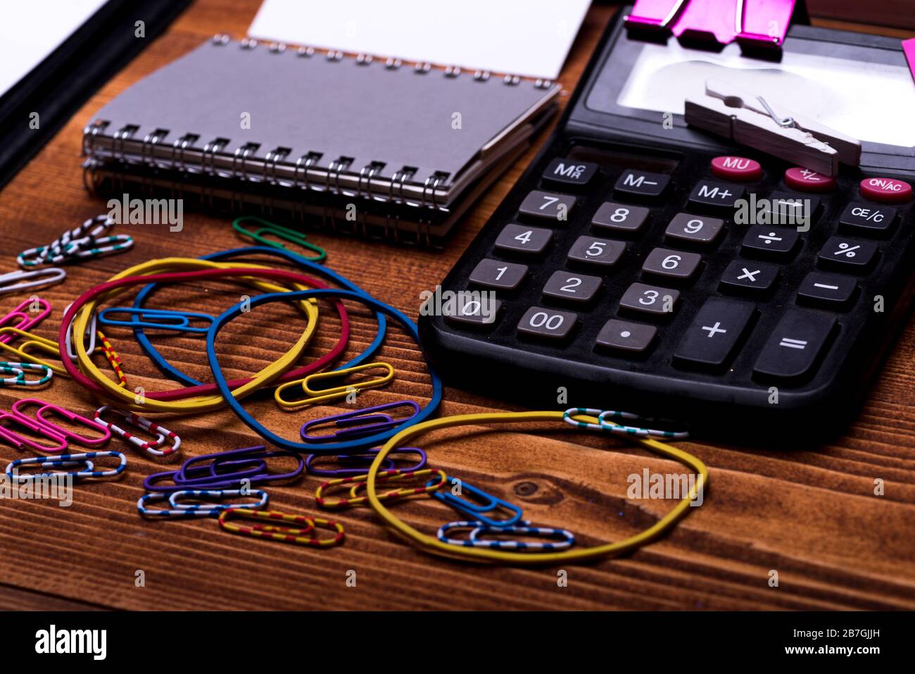 Business idea concept. Notebook, colored elastics and paper clips on ...