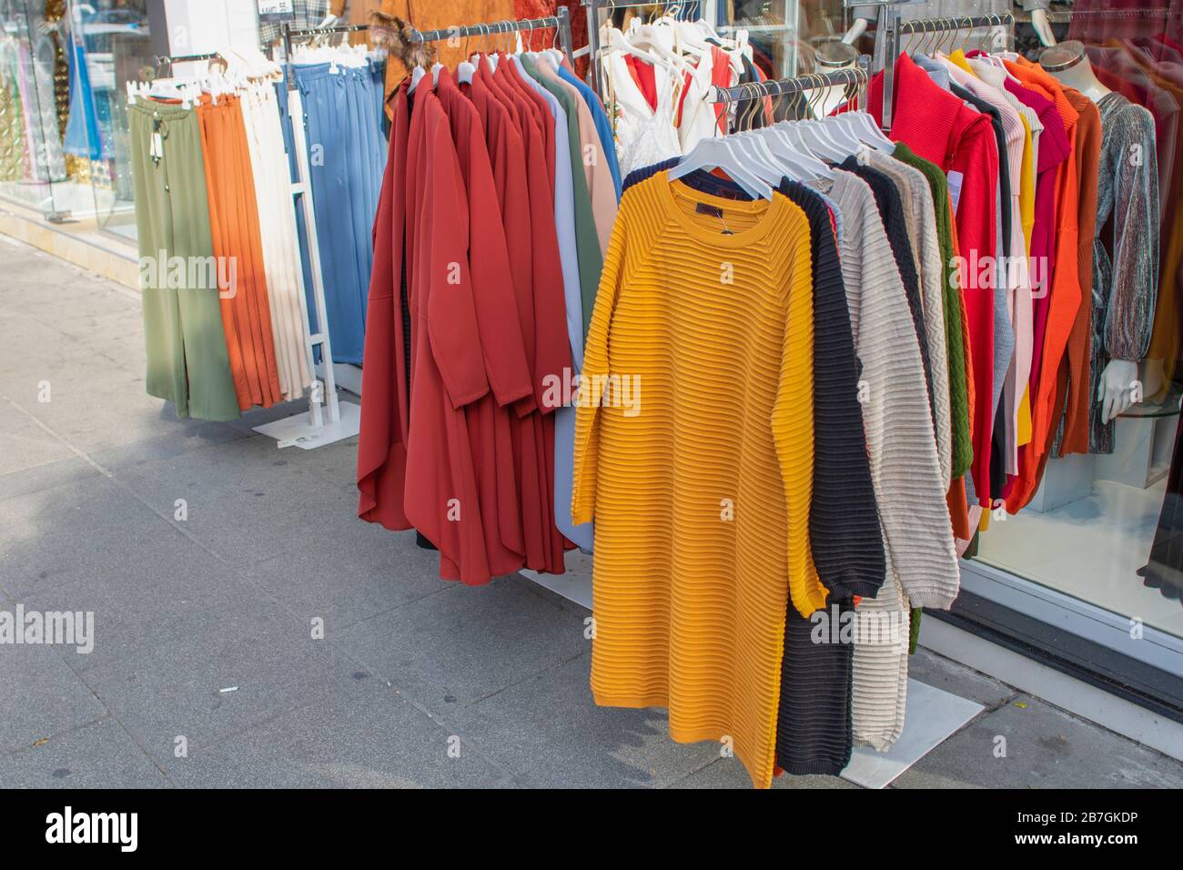 Clothes with different patterns and varieties hanging in front of the ...