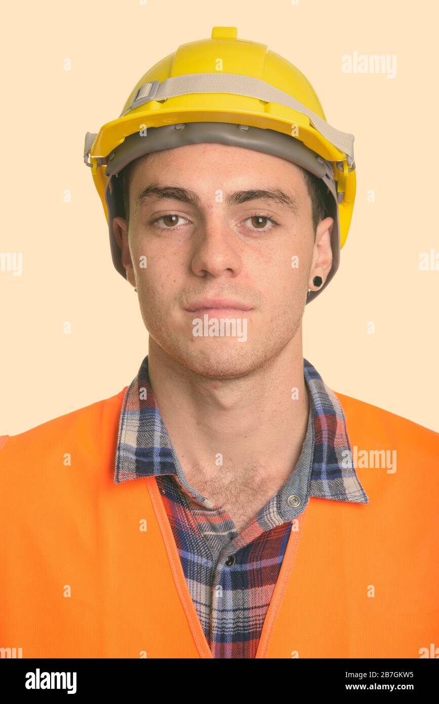 Studio shot of young man construction worker isolated against white ...