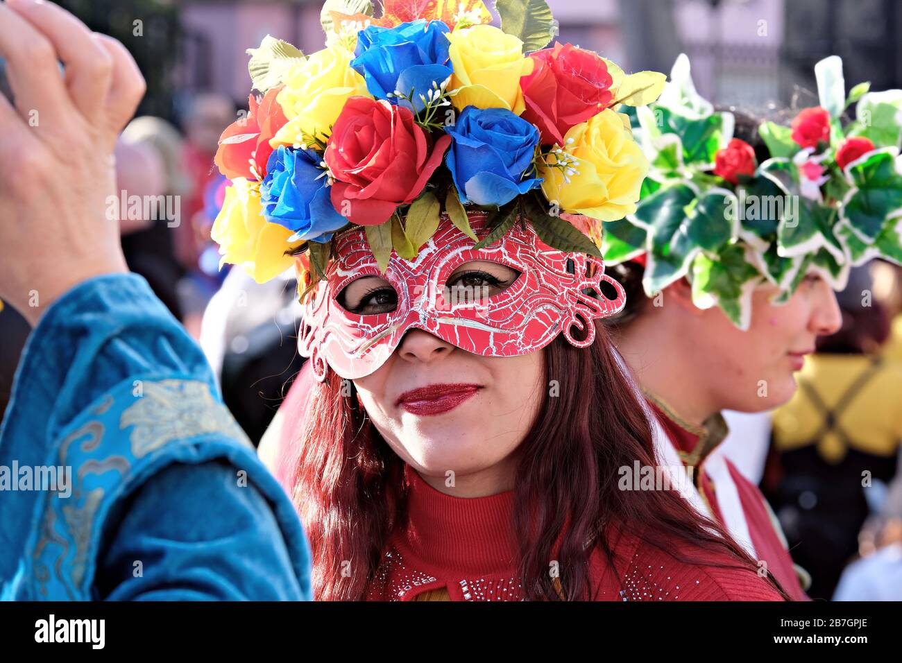 Masked girl posing for a picture at the carnival parade Stock Photo - Alamy