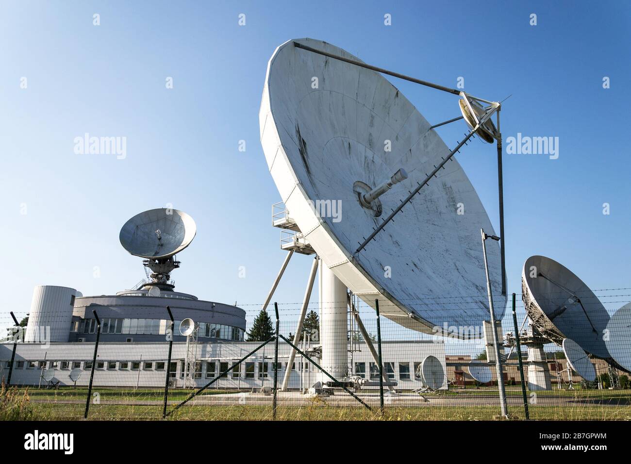 Barbed wire fence around satellite links center with telecommunication ...
