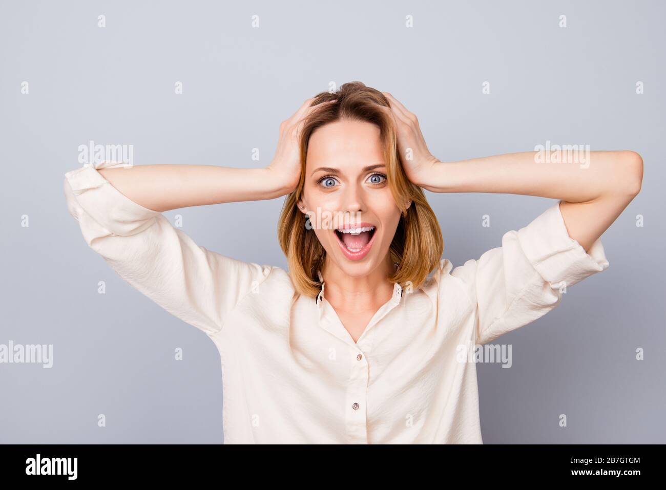 Wow! It's unbelievable! Shocked happy woman with opened mouth touching ...