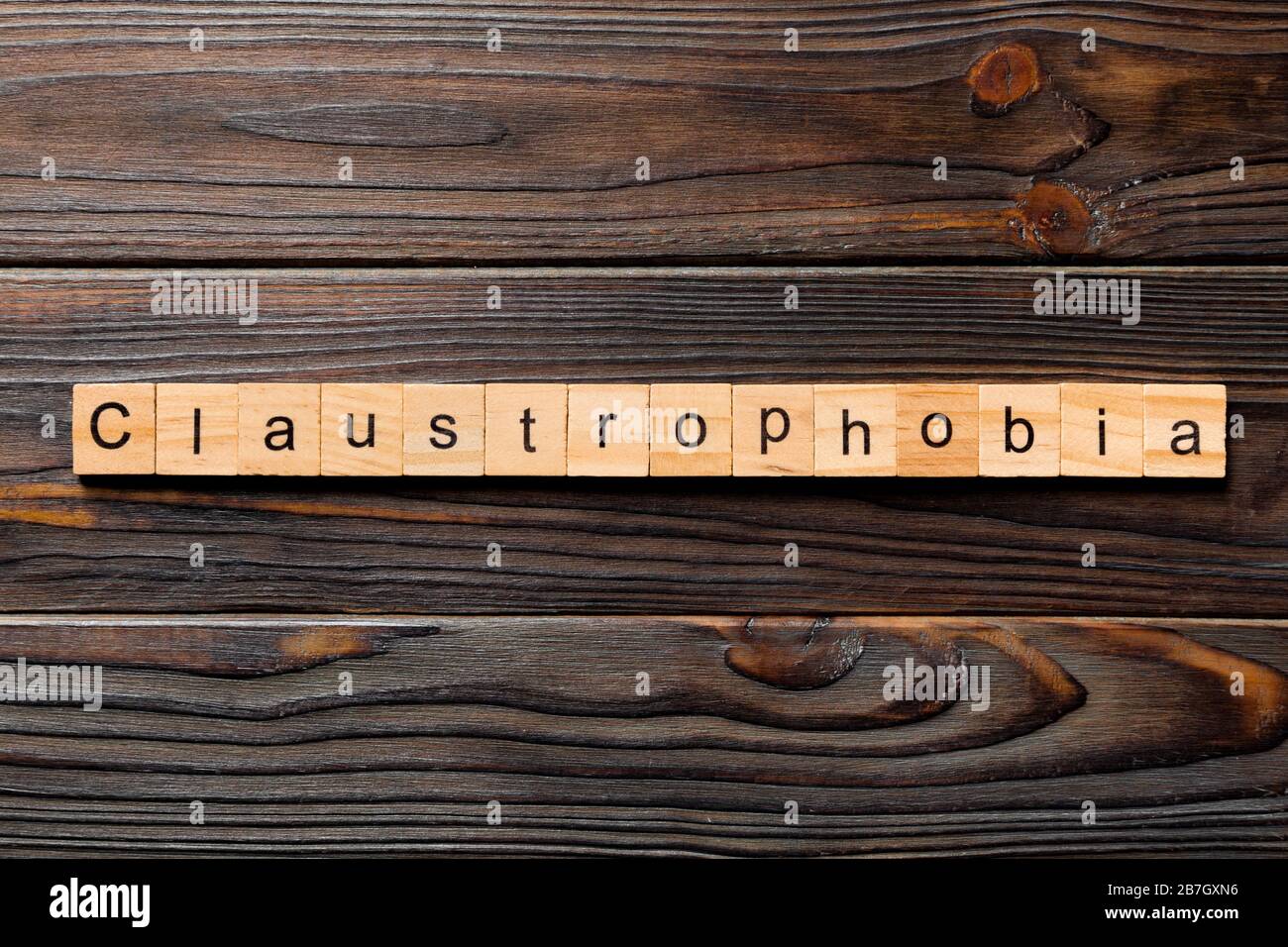 claustrophobia word written on wood block. claustrophobia text on table ...