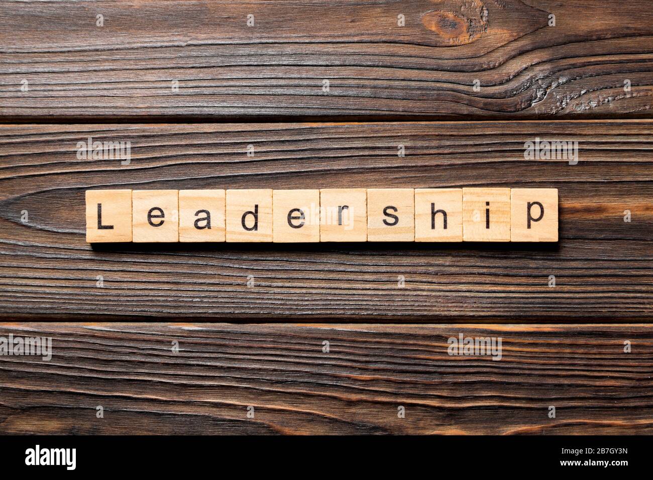 LEADERSHIP word written on wood block. LEADERSHIP text on table ...