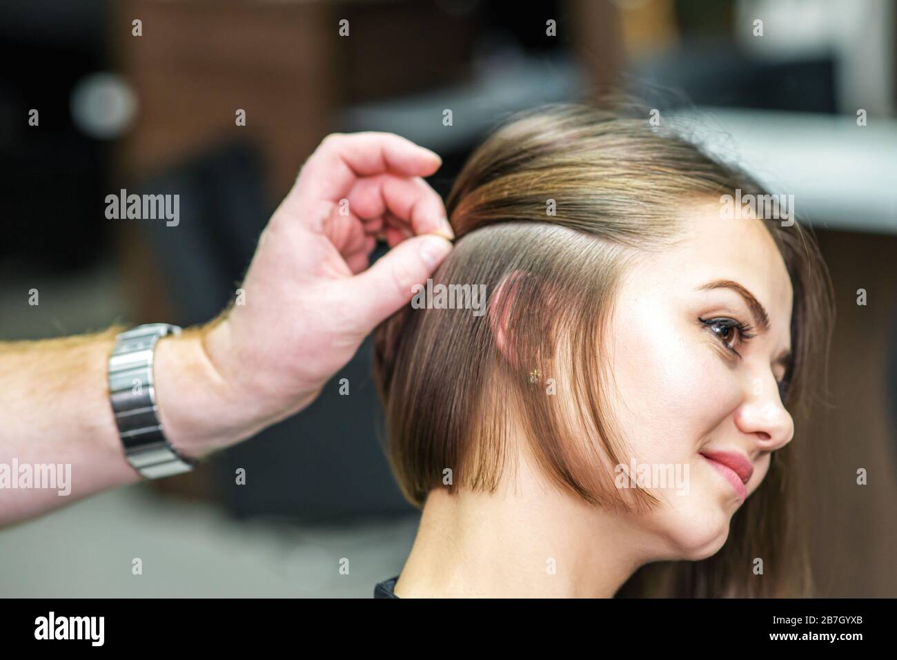 Hairdresser combs hair of woman at hair salon Stock Photo - Alamy