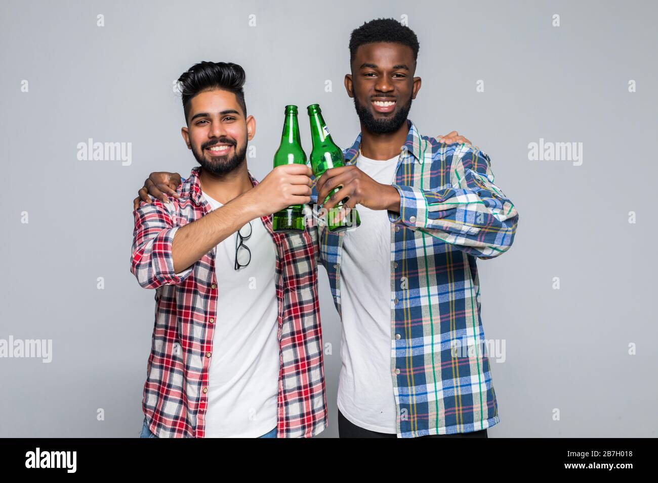 Portrait of a two happy young men best friends toasting with beer ...