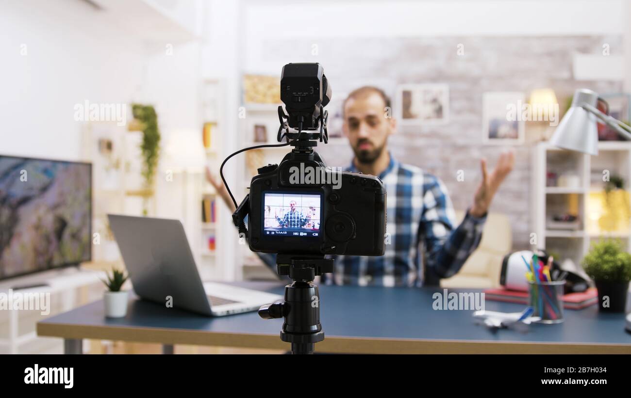 Young and cheerful vlogger recording for subscribers. Famous influencer ...