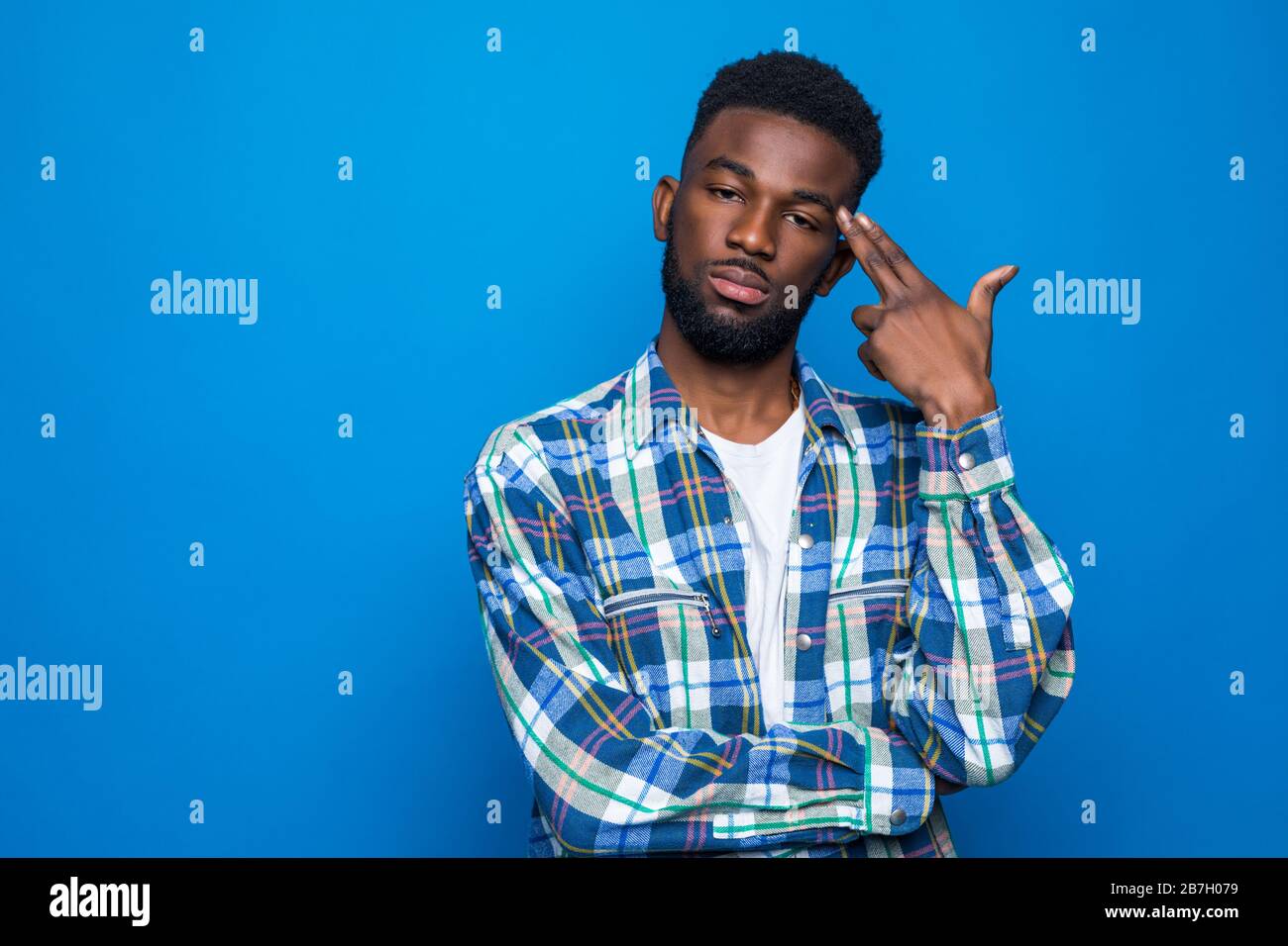 Young handsome man pointing gun hi-res stock photography and images - Alamy