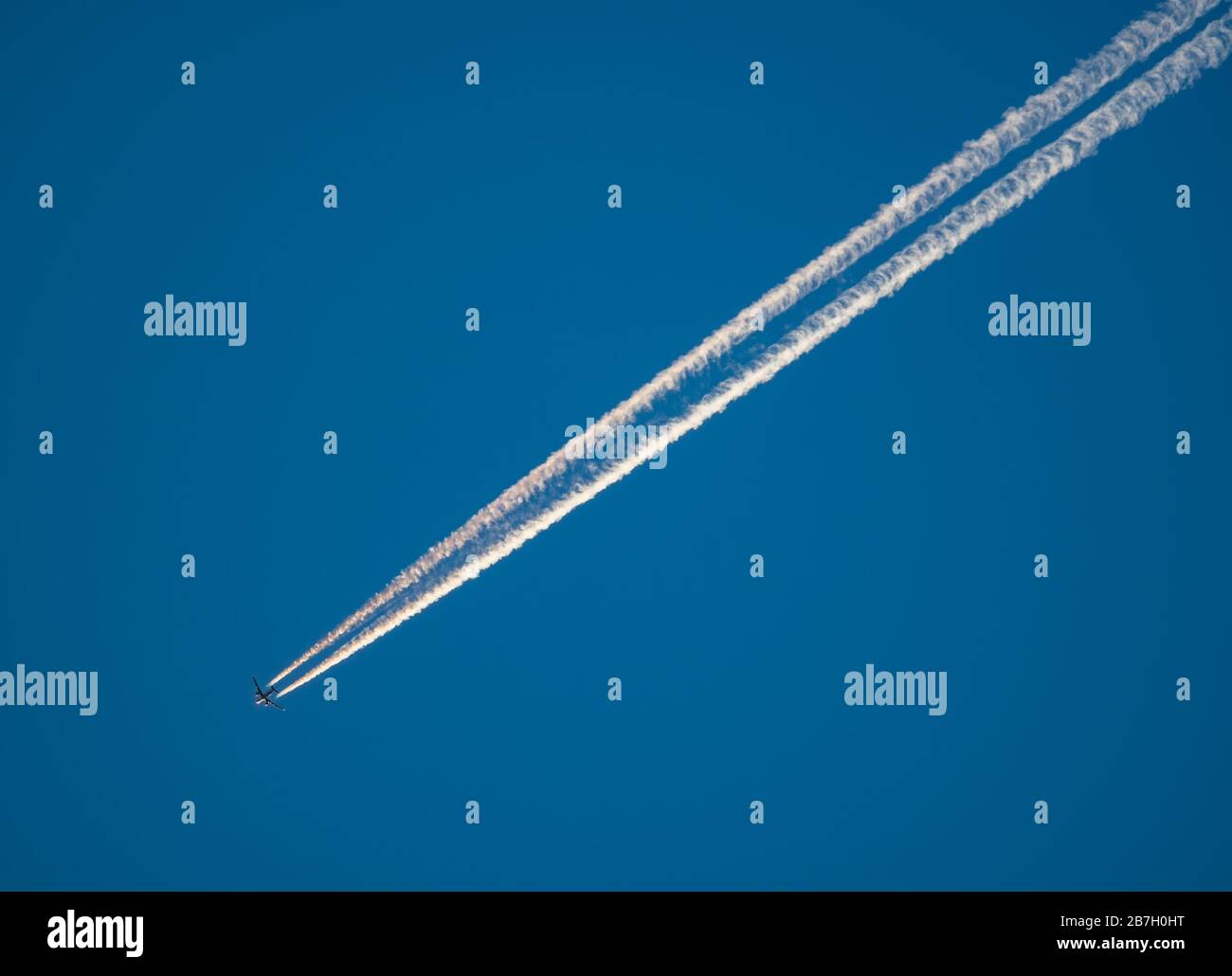 Jet plane trail crosses the sky from top right to bottom left Stock ...