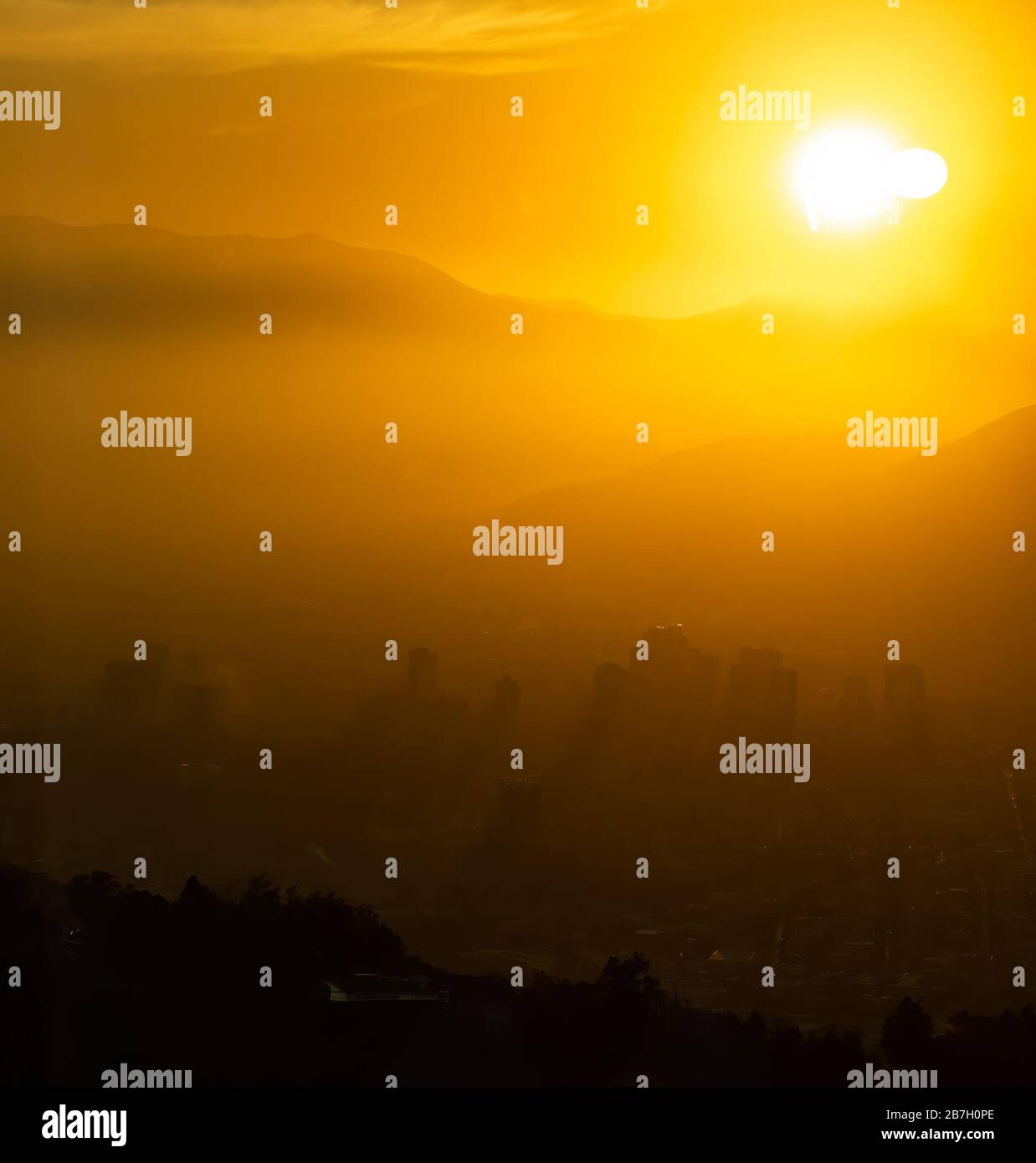 Bright orange sunset over the city silhouette Stock Photo - Alamy
