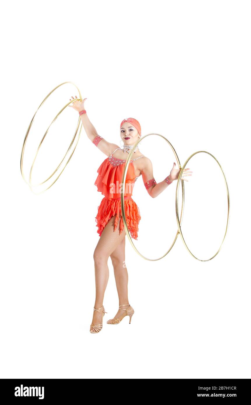 A woman in a stage dress performs a dance with a hula Hoop. Studio ...