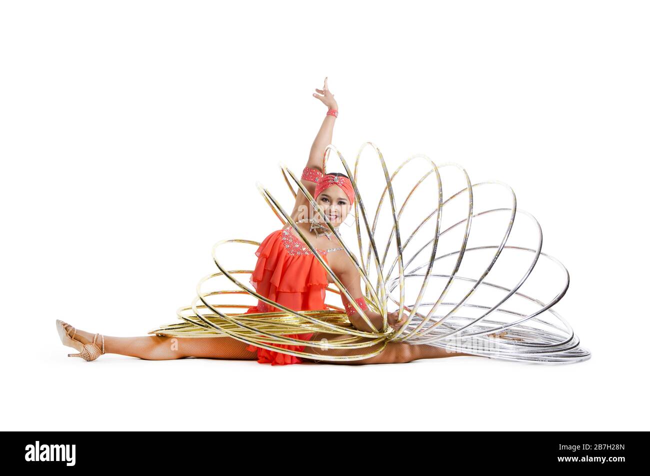 A woman in a stage dress performs a dance with a hula Hoop. Studio ...