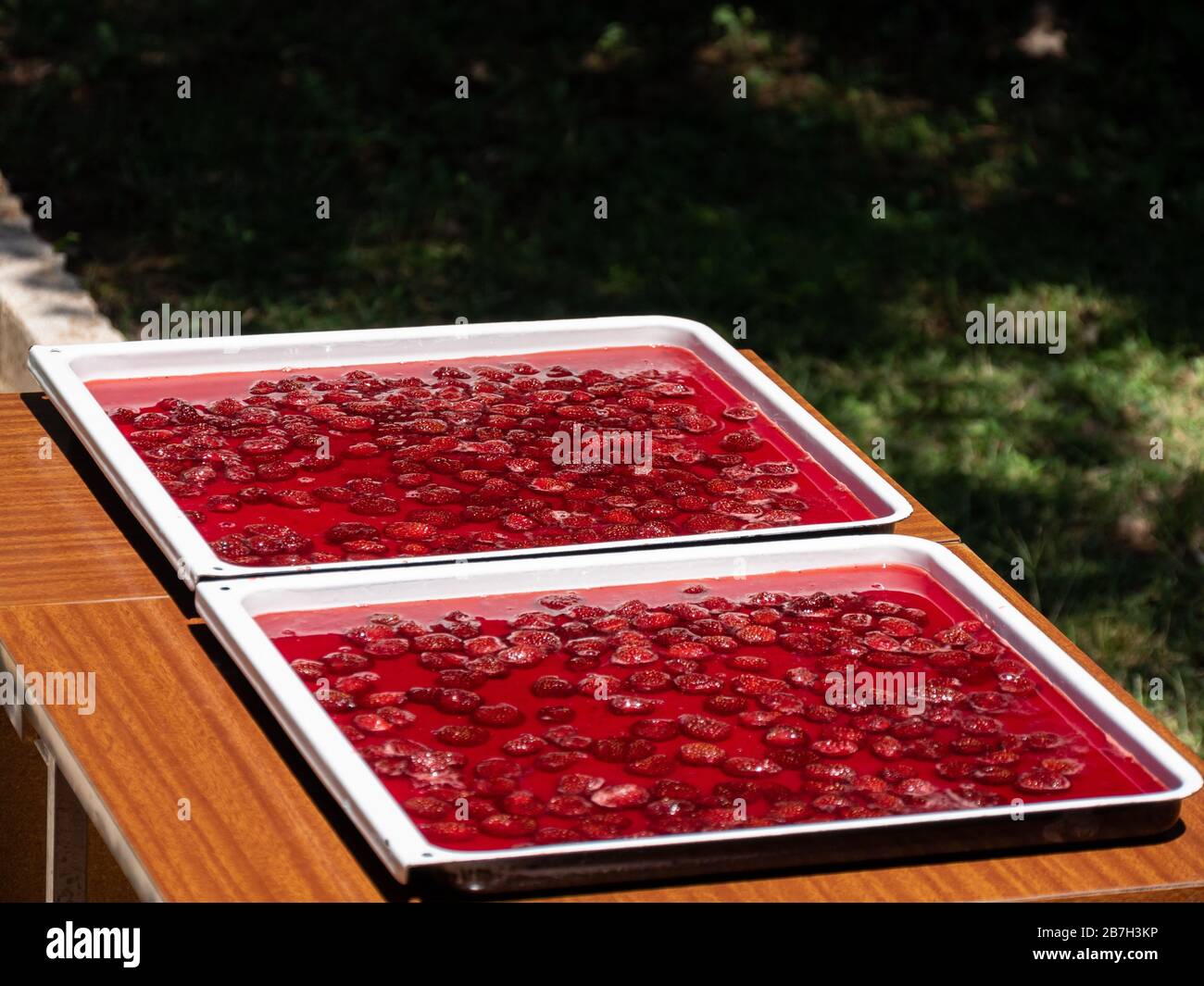 Strawberry jam is making under the sun. Jam Traditional dried with sun ...