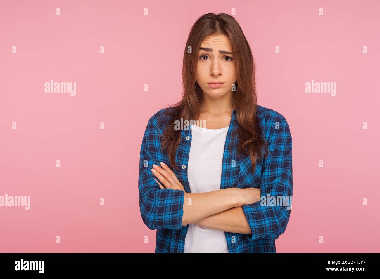 Portrait of displeased unhappy brunette girl in bad mood looking at ...