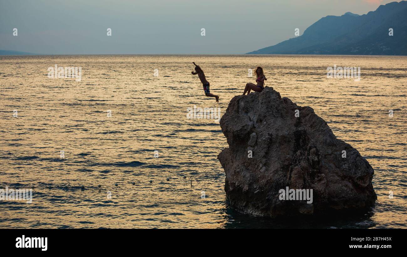 Cliff jumping into ocean sunset hi-res stock photography and images - Alamy