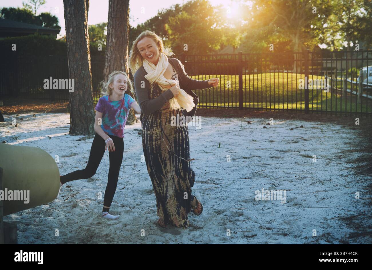 Mother and daughter running and playing at the backyard Stock Photo - Alamy