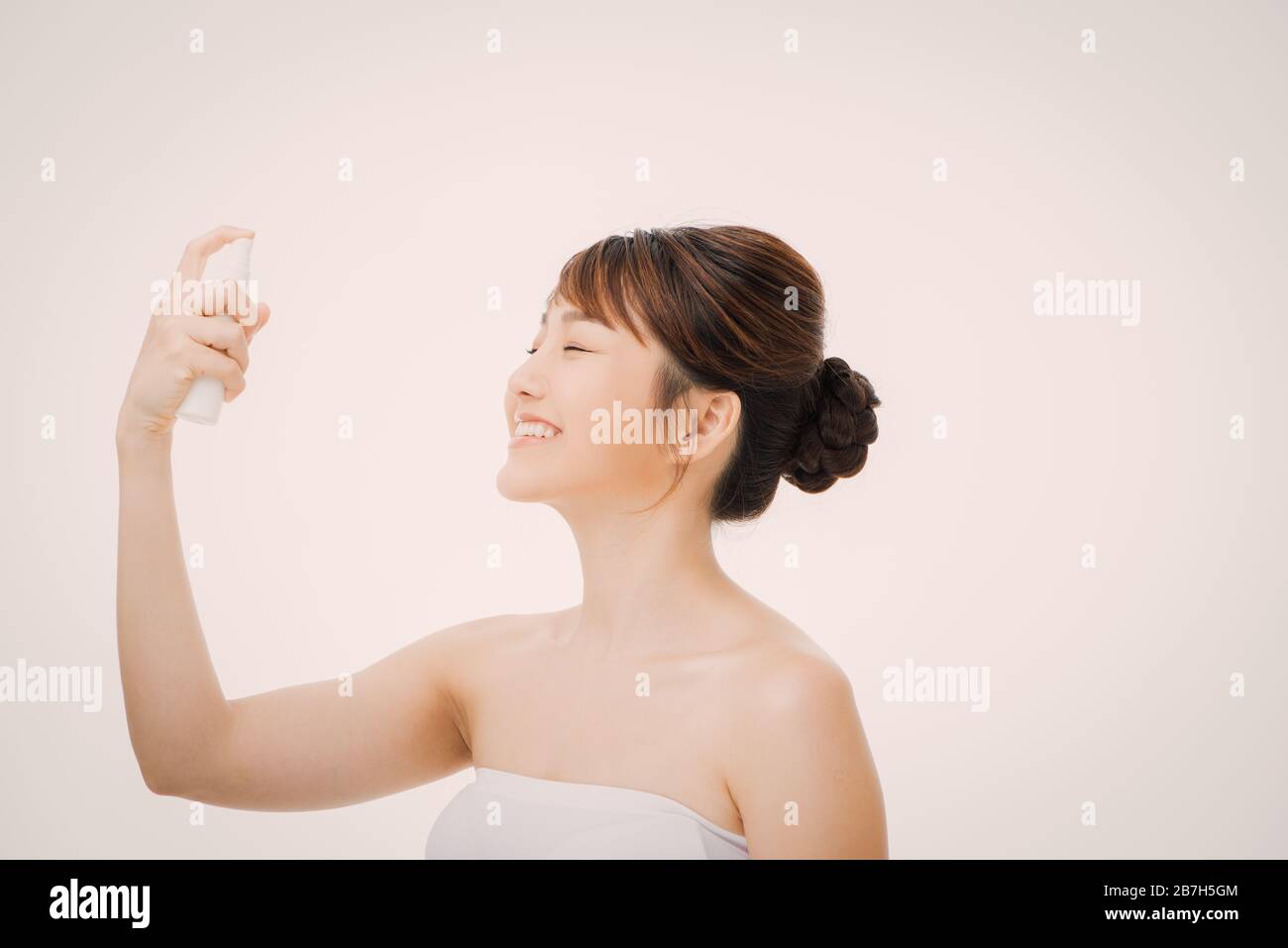 Beautiful woman face spray on face lotion cosmetology on white ...