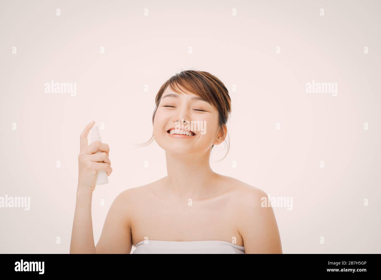 Beautiful woman face spray on face lotion cosmetology on white ...